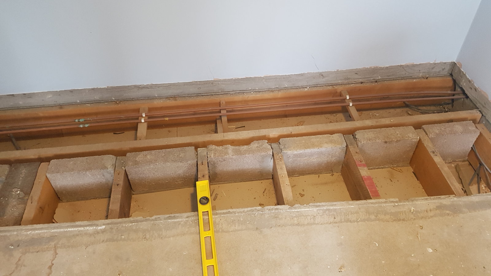 Upstairs floor straddles block wall and joists at different levels ...